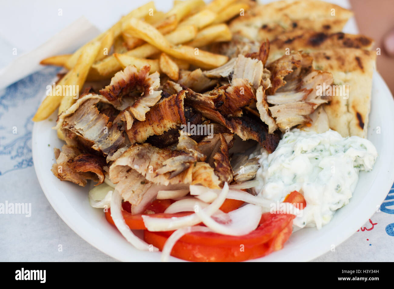 Greek tasty fast food, gyros and fried potato , tomato and onion Stock ...
