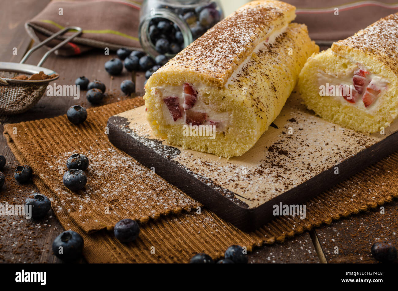 Sponge roll stuffed with strawberry cream Stock Photo - Alamy