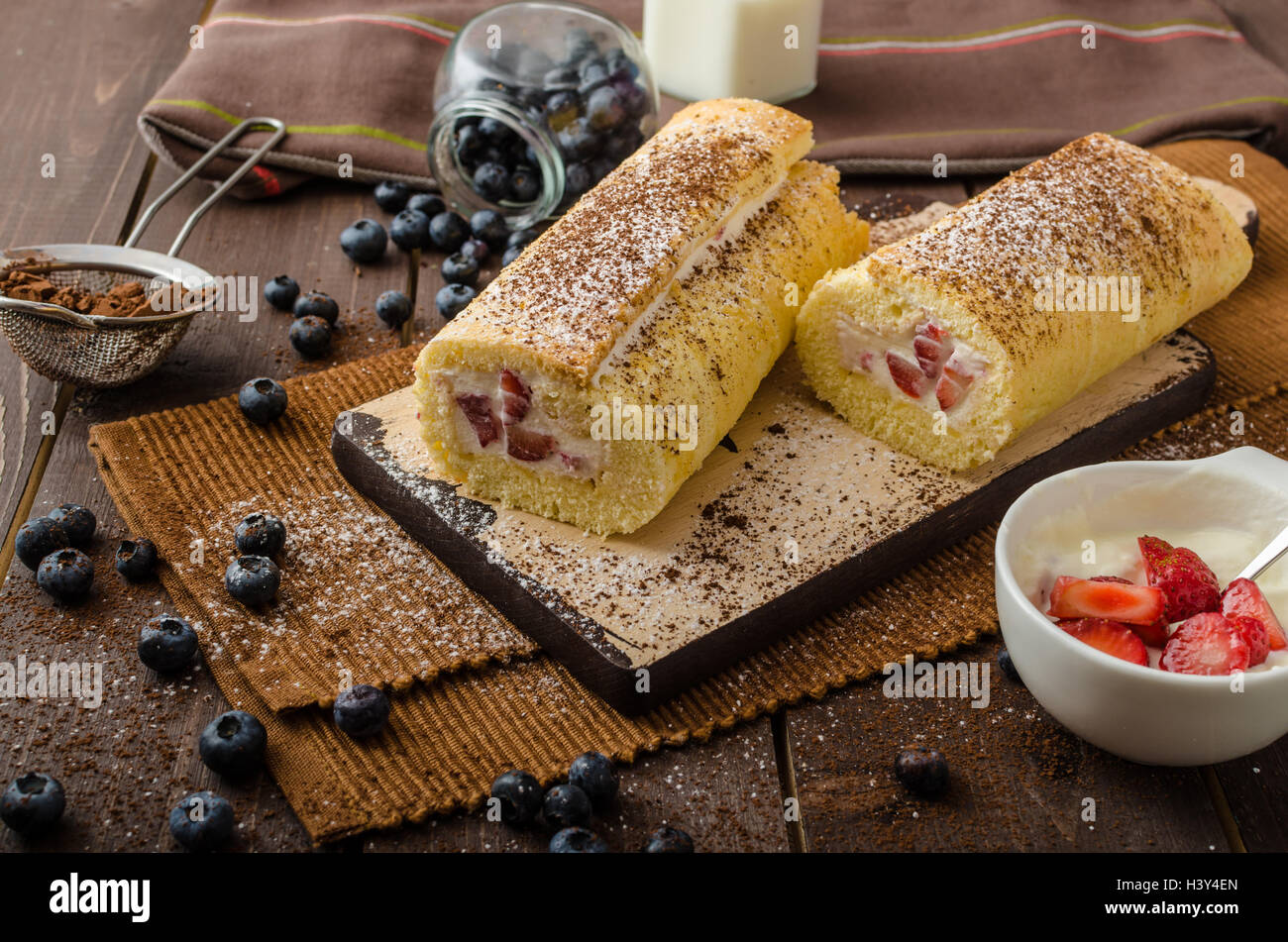 Sponge roll stuffed with strawberry cream Stock Photo - Alamy