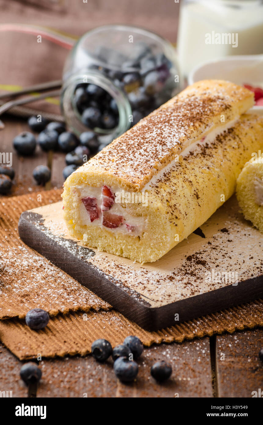 Sponge roll stuffed with strawberry cream Stock Photo - Alamy