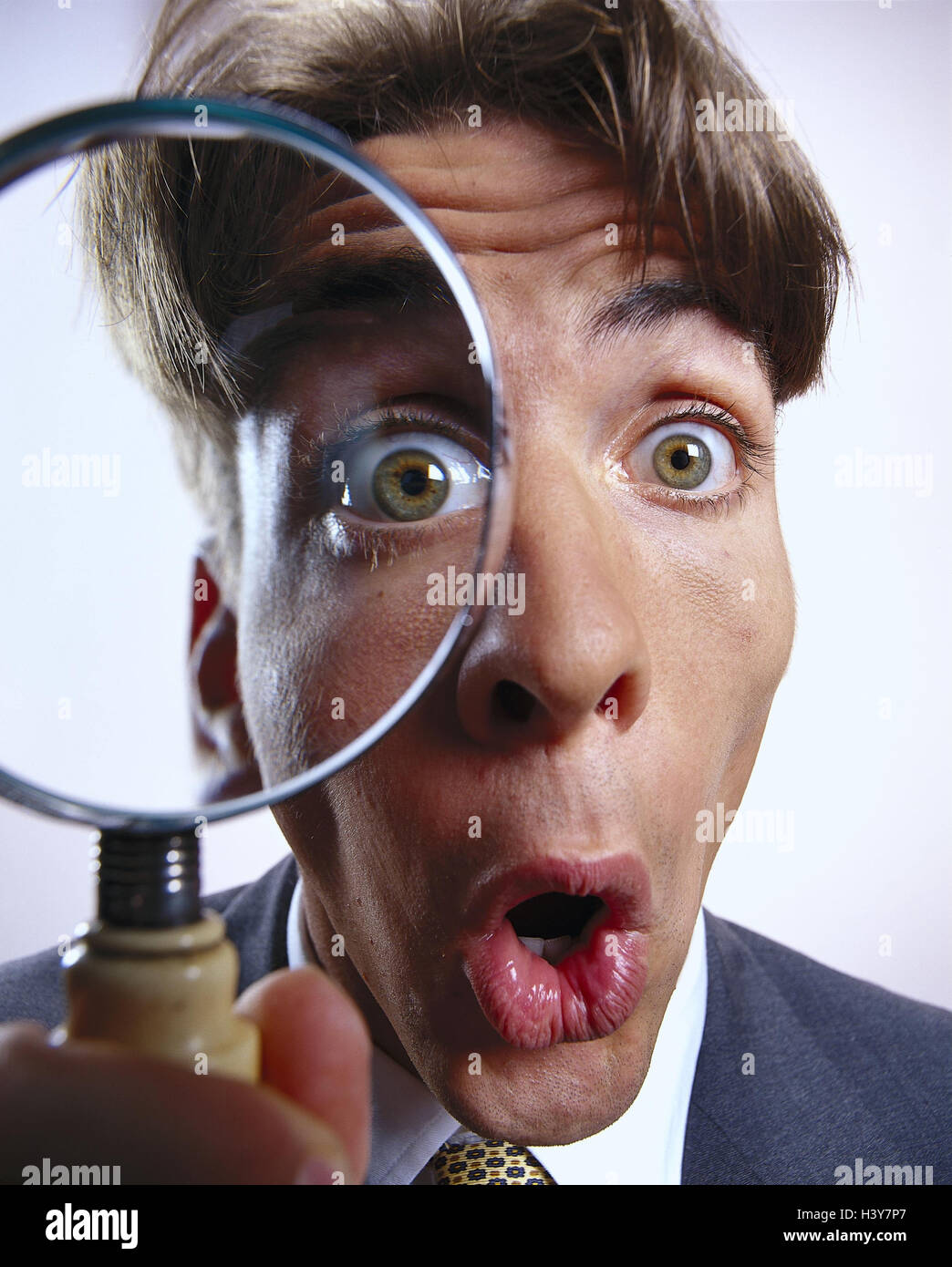 Man, astonished young, view loupe, facial play, portrait, suit ...