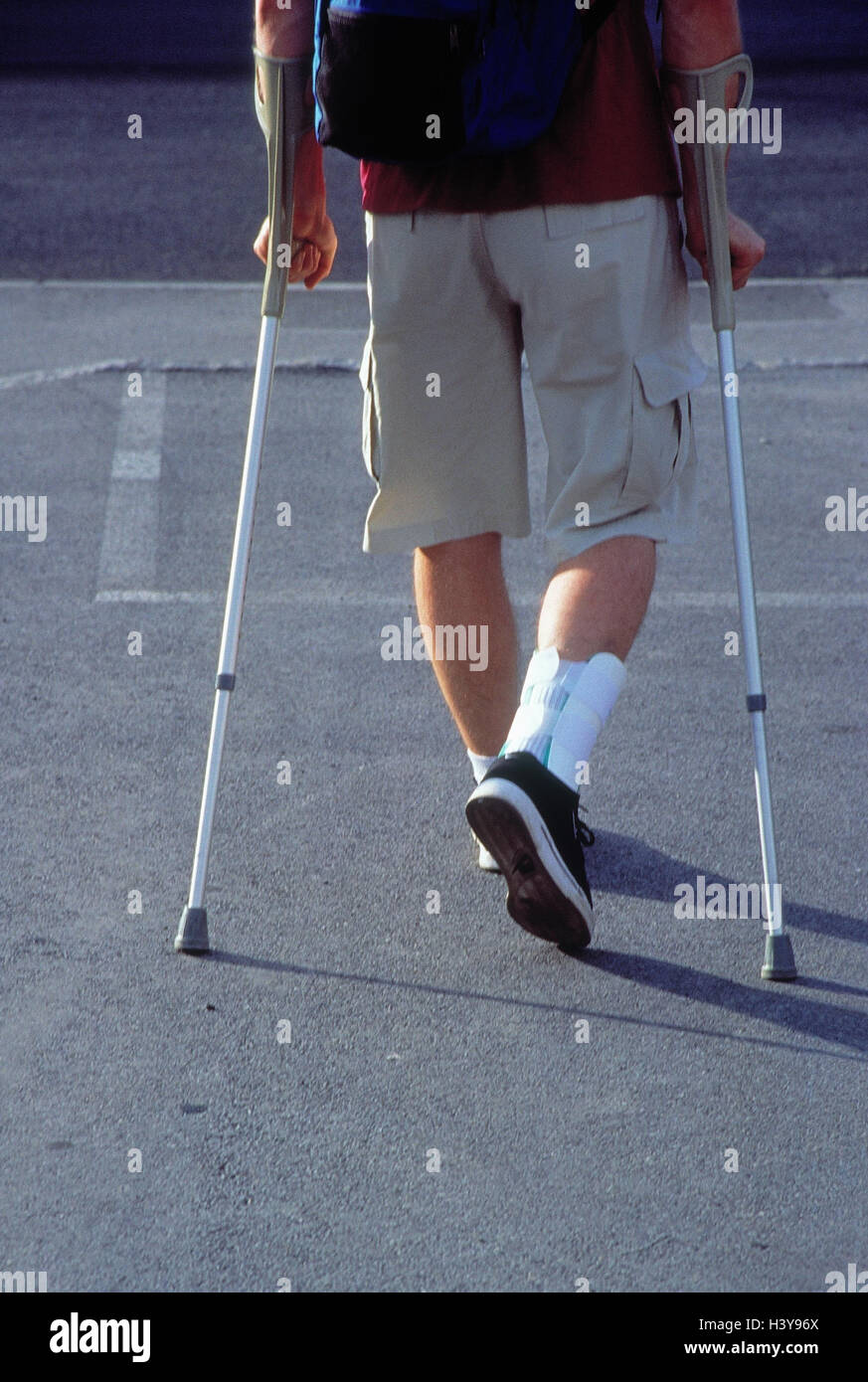 Man, detail, bone injury, walking help, back view, outside, summer ...