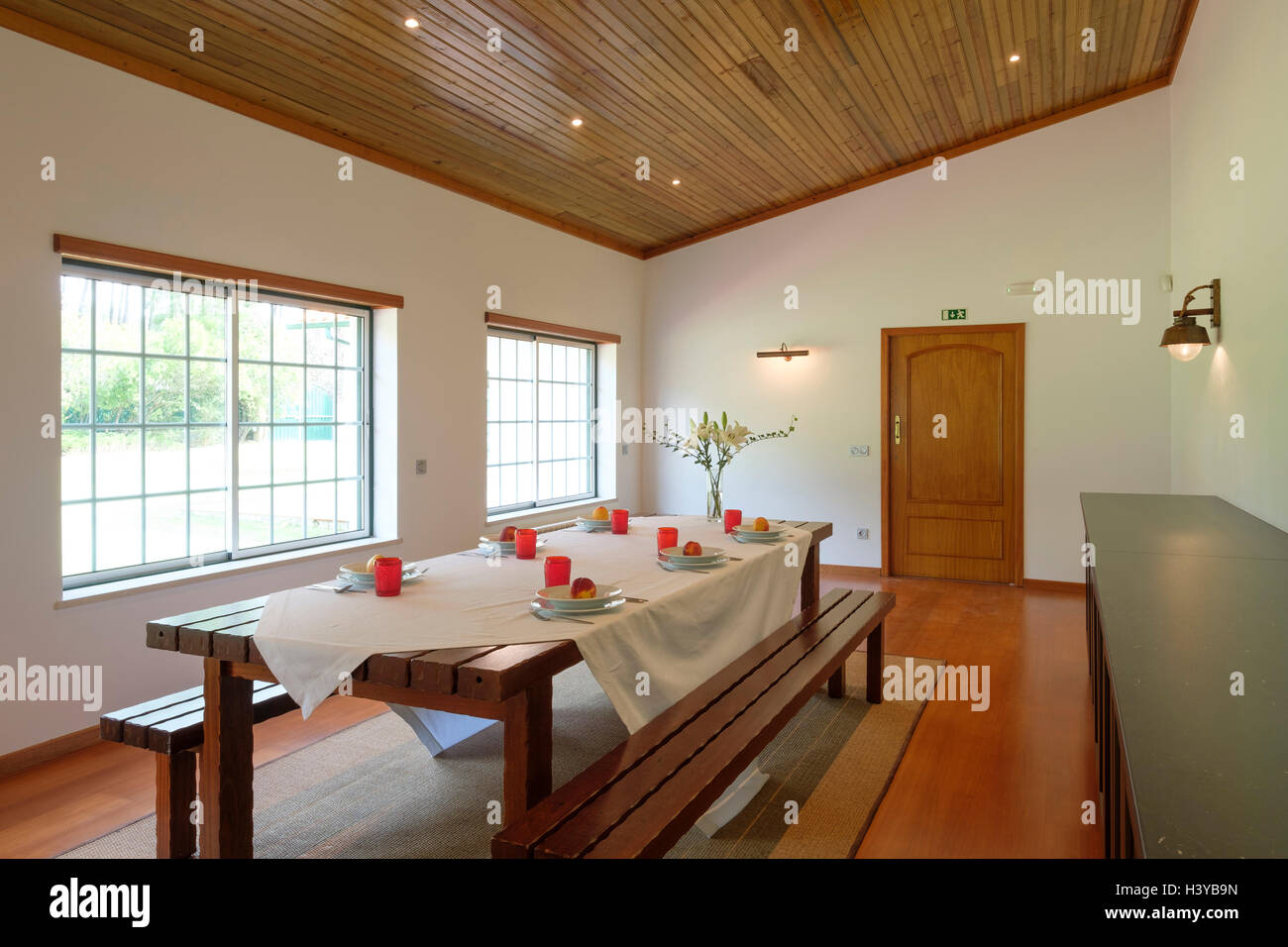 Dining room with a big wooden table Stock Photo - Alamy