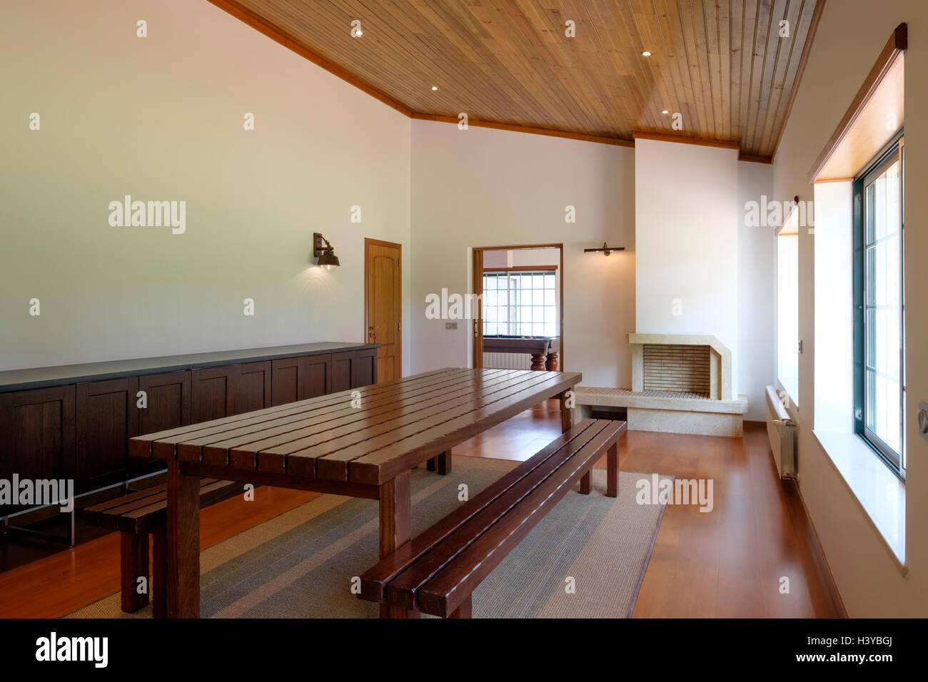 Dining room with a big wooden table Stock Photo - Alamy