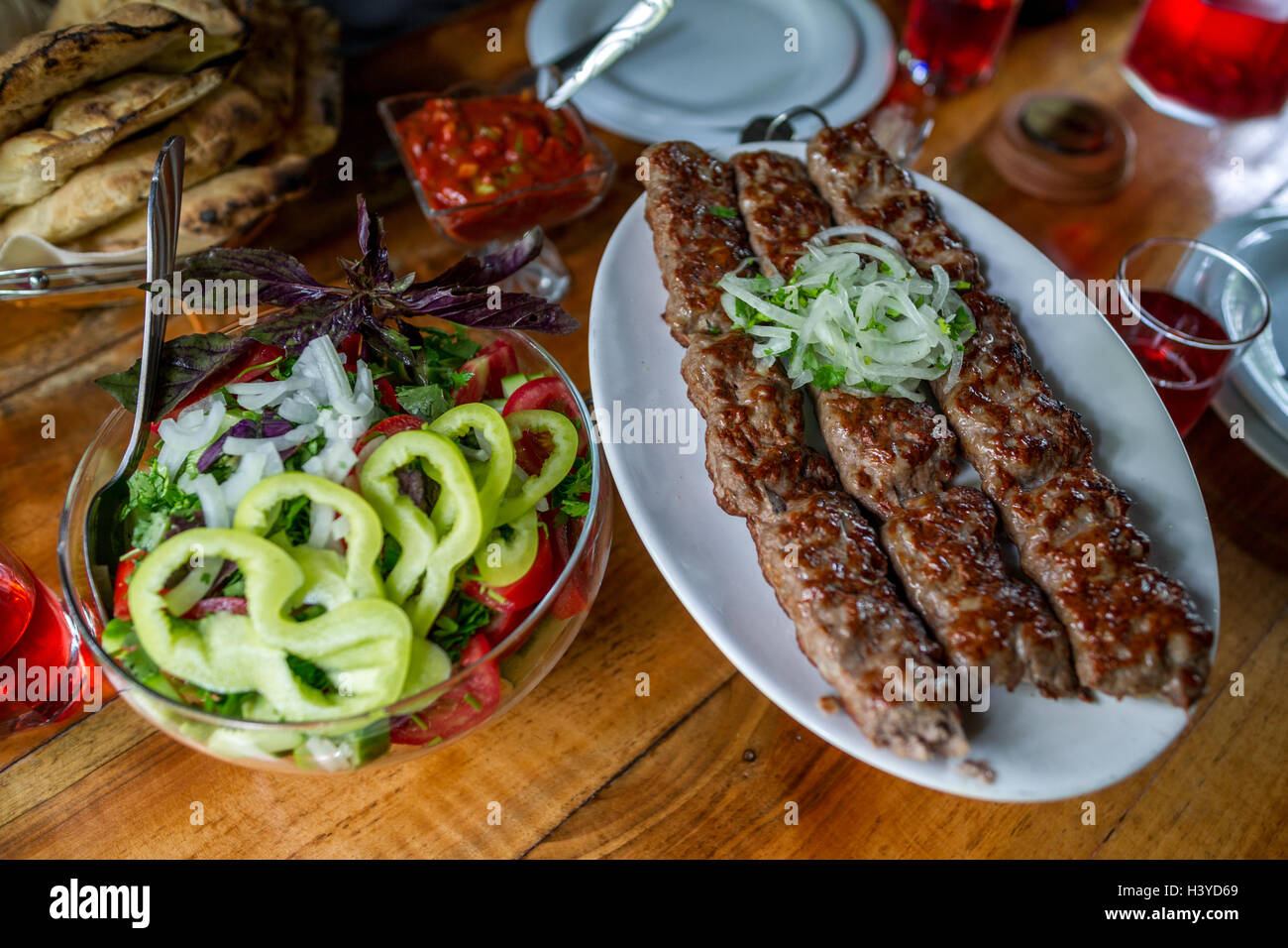 Armenian traditional food khorovats (a sort of kebab) served with salad ...