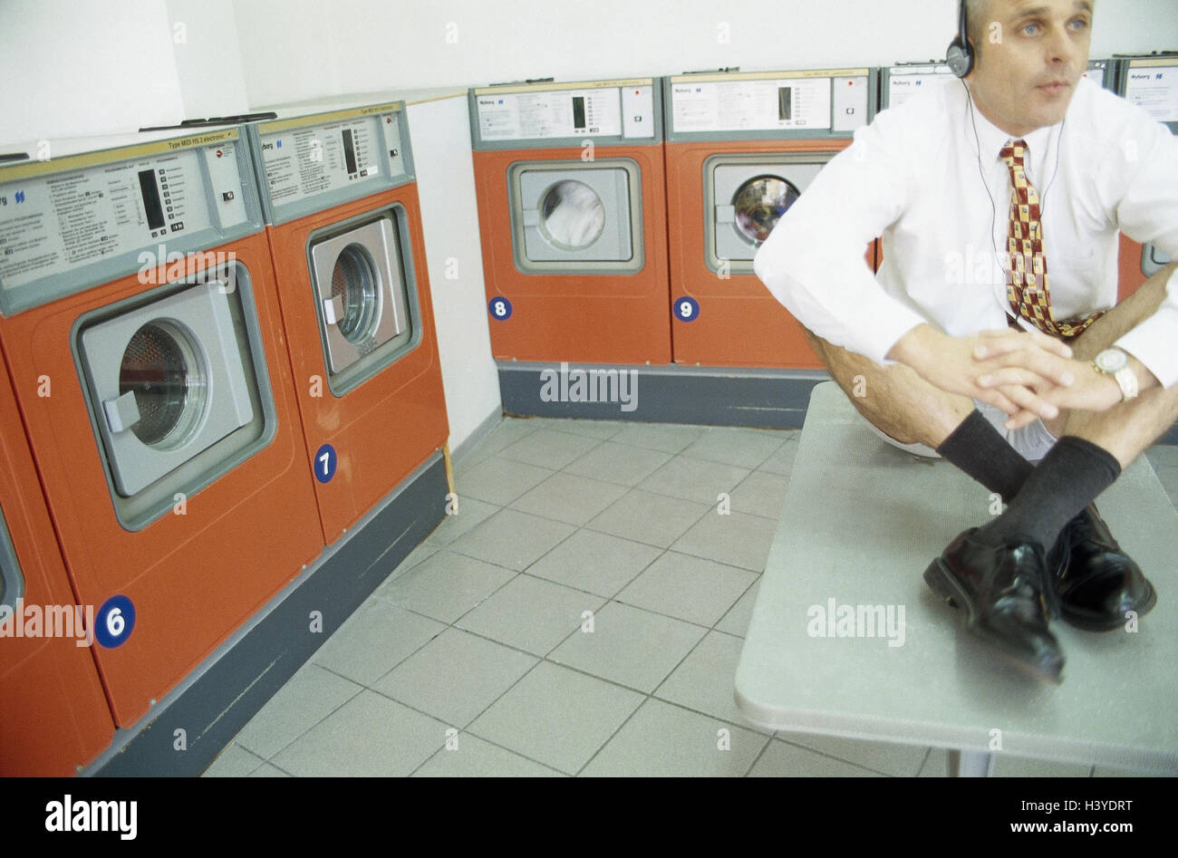 Launderette, man, underpants, Walkman, wait, model released, coin ...
