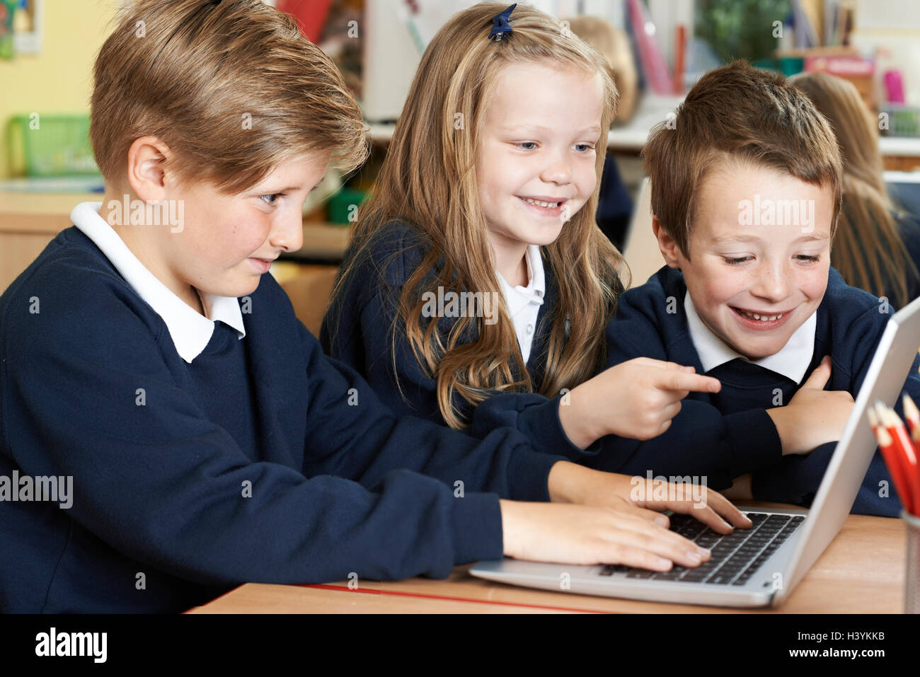 Group Of Elementary School Children Working Together In Computer Class ...