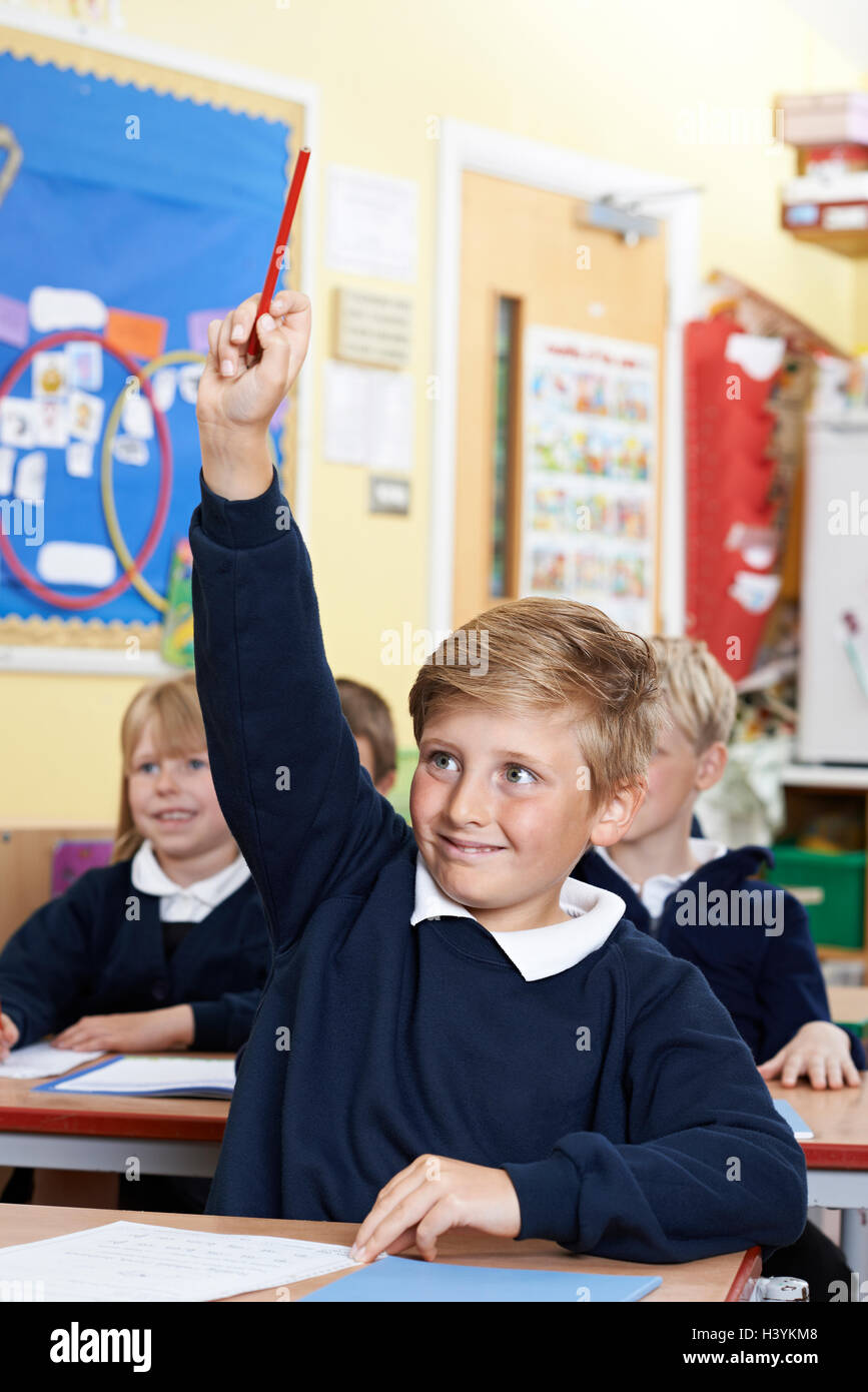 Elementary School Pupil Answering Question In Class Stock Photo - Alamy
