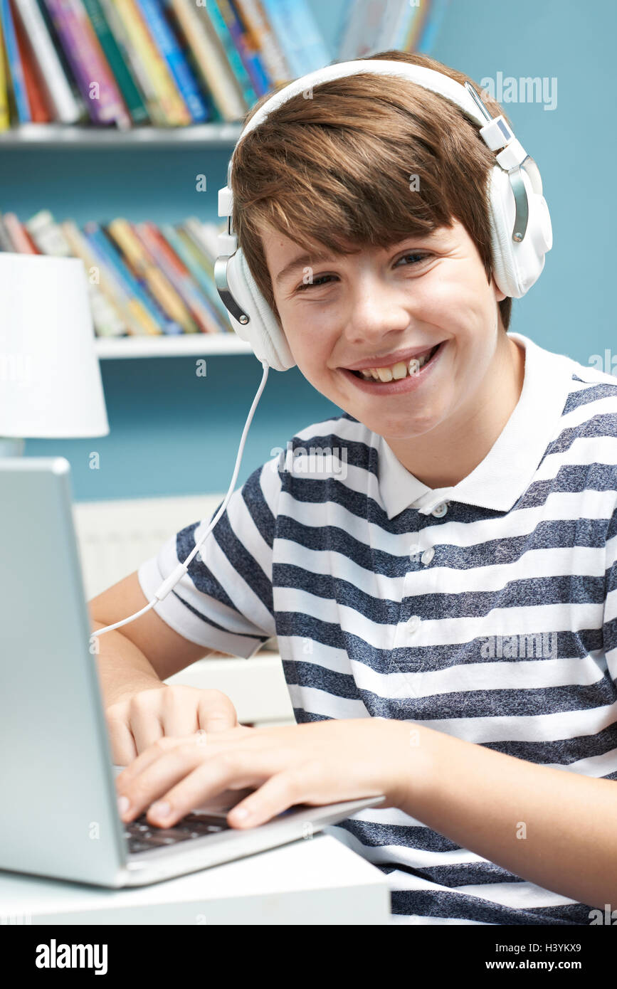 Teenage Boy Using Technology In Bedroom Stock Photo - Alamy