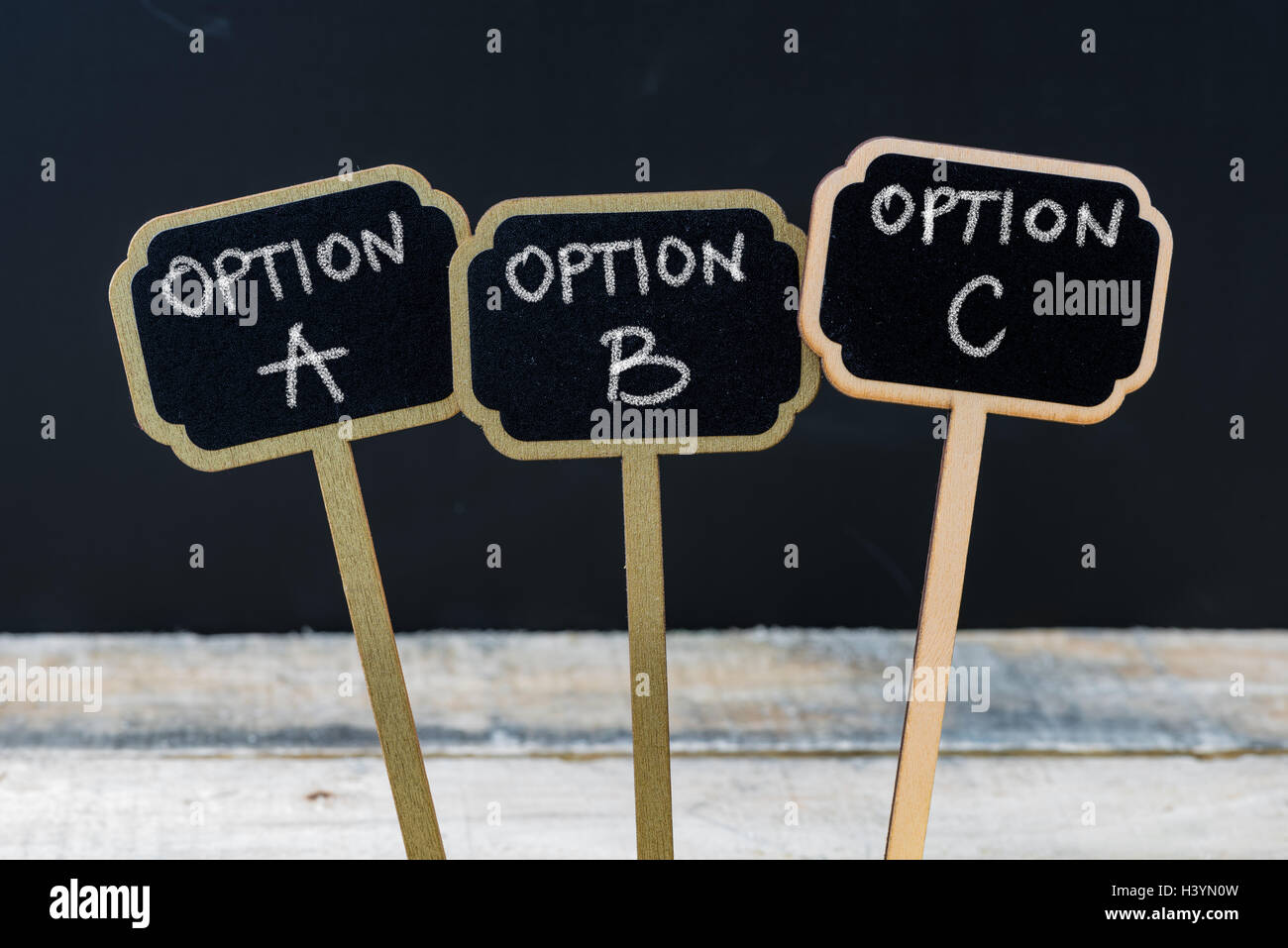 Business message Option A, Option B, Option C written with chalk on ...