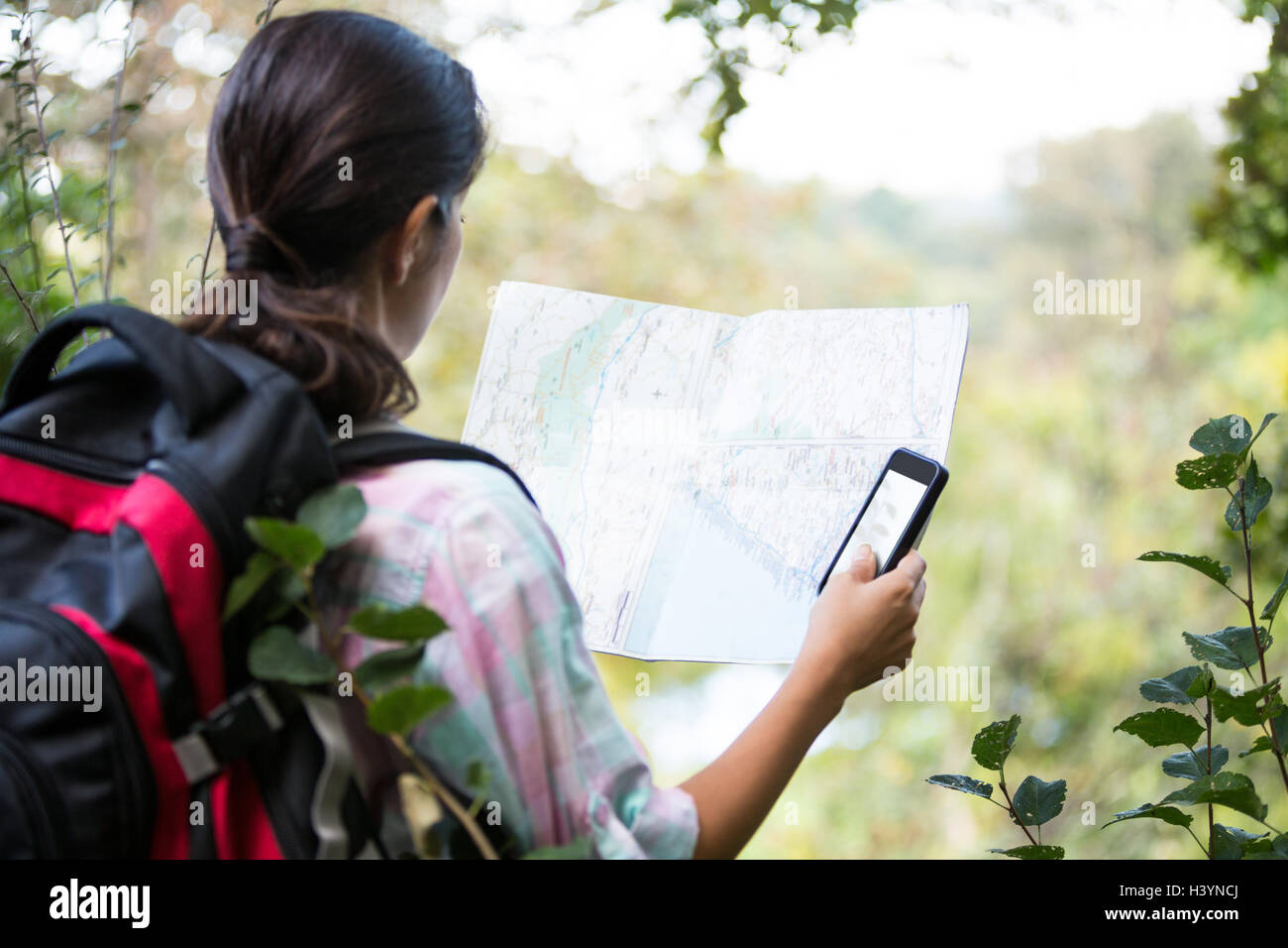 Female hiker looking at map Stock Photo - Alamy