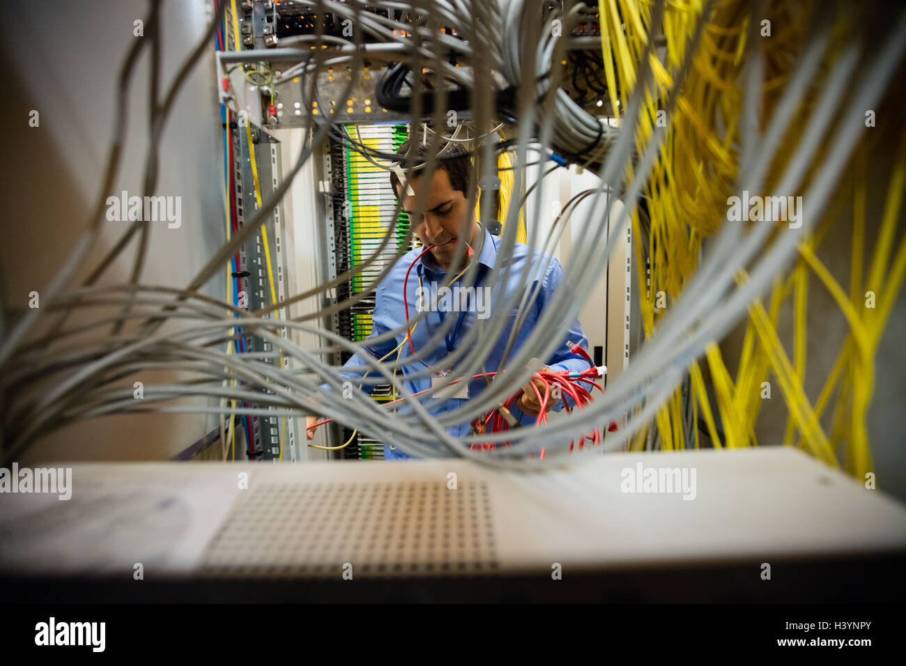 Technician fixing cable Stock Photo - Alamy Technician fixing cable Stock Photo - Alamy