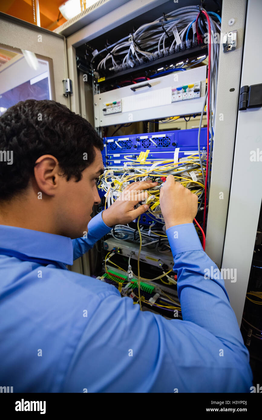 Technician checking cables in a rack mounted server Stock Photo - Alamy