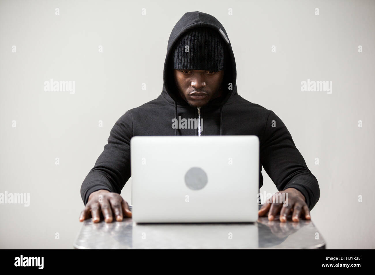 Hacker using a laptop Stock Photo - Alamy