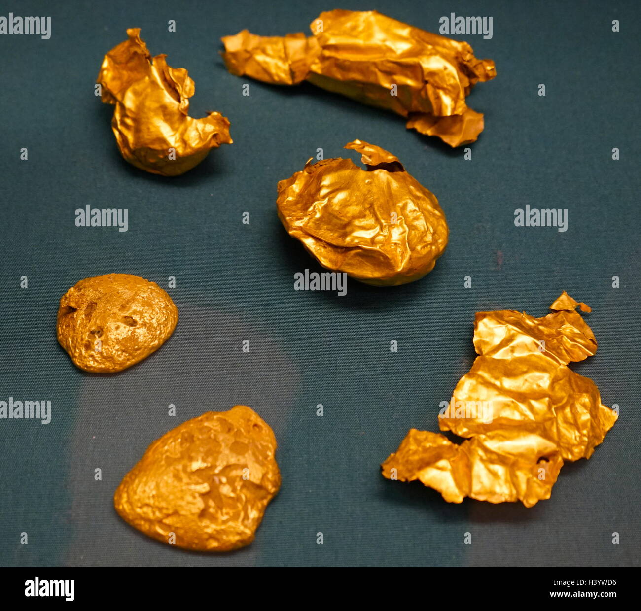 Fragments from a gold tubular torc, with globular terminals, triangular ...