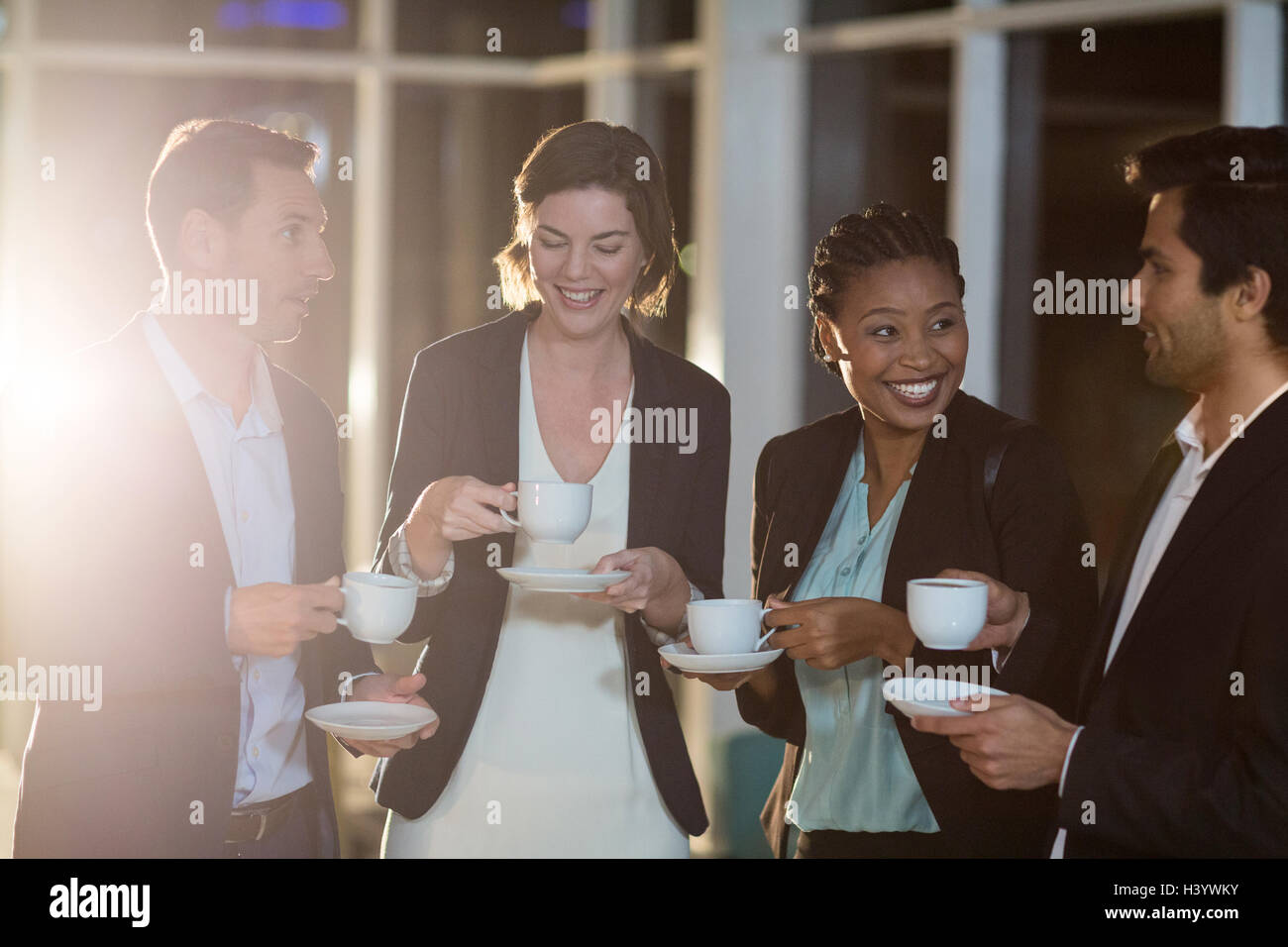 Group of businesspeople having coffee during break Stock Photo - Alamy