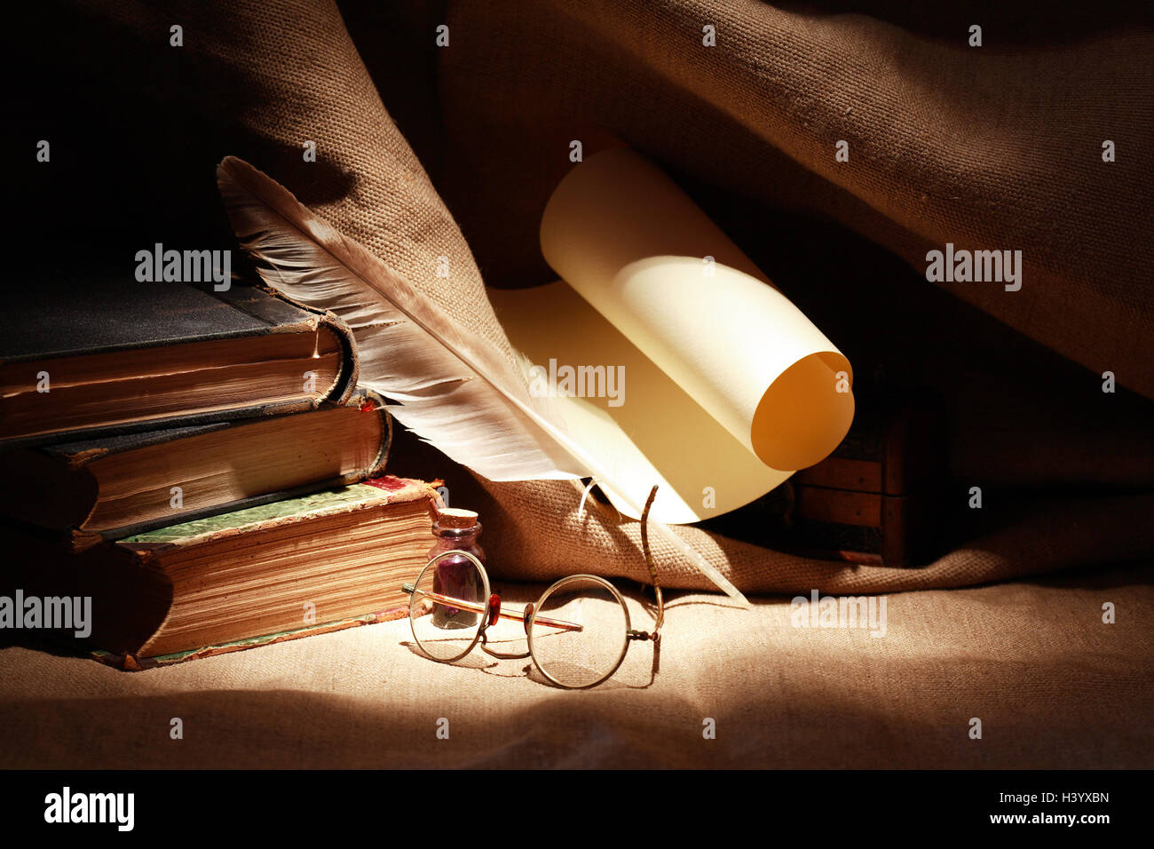 Stack of old books near quill and scroll on canvas background Stock ...