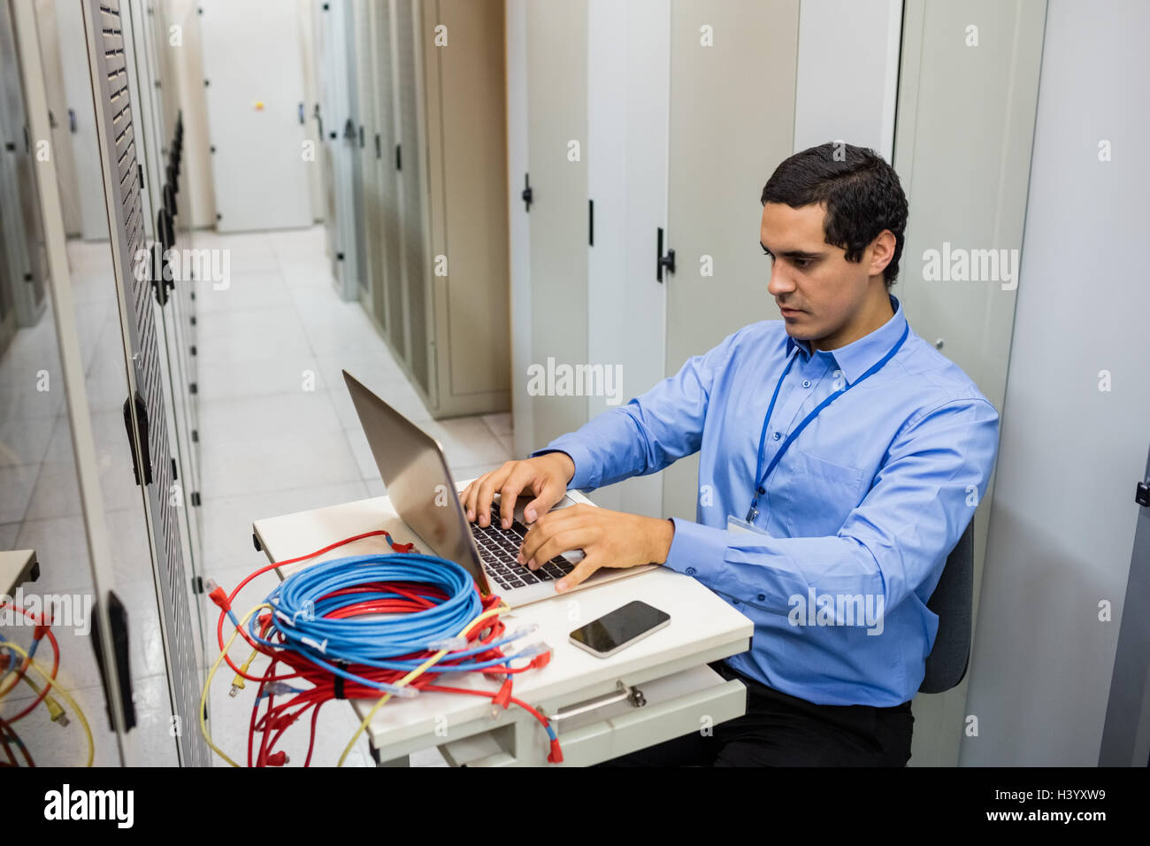 Technician working on laptop Stock Photo - Alamy