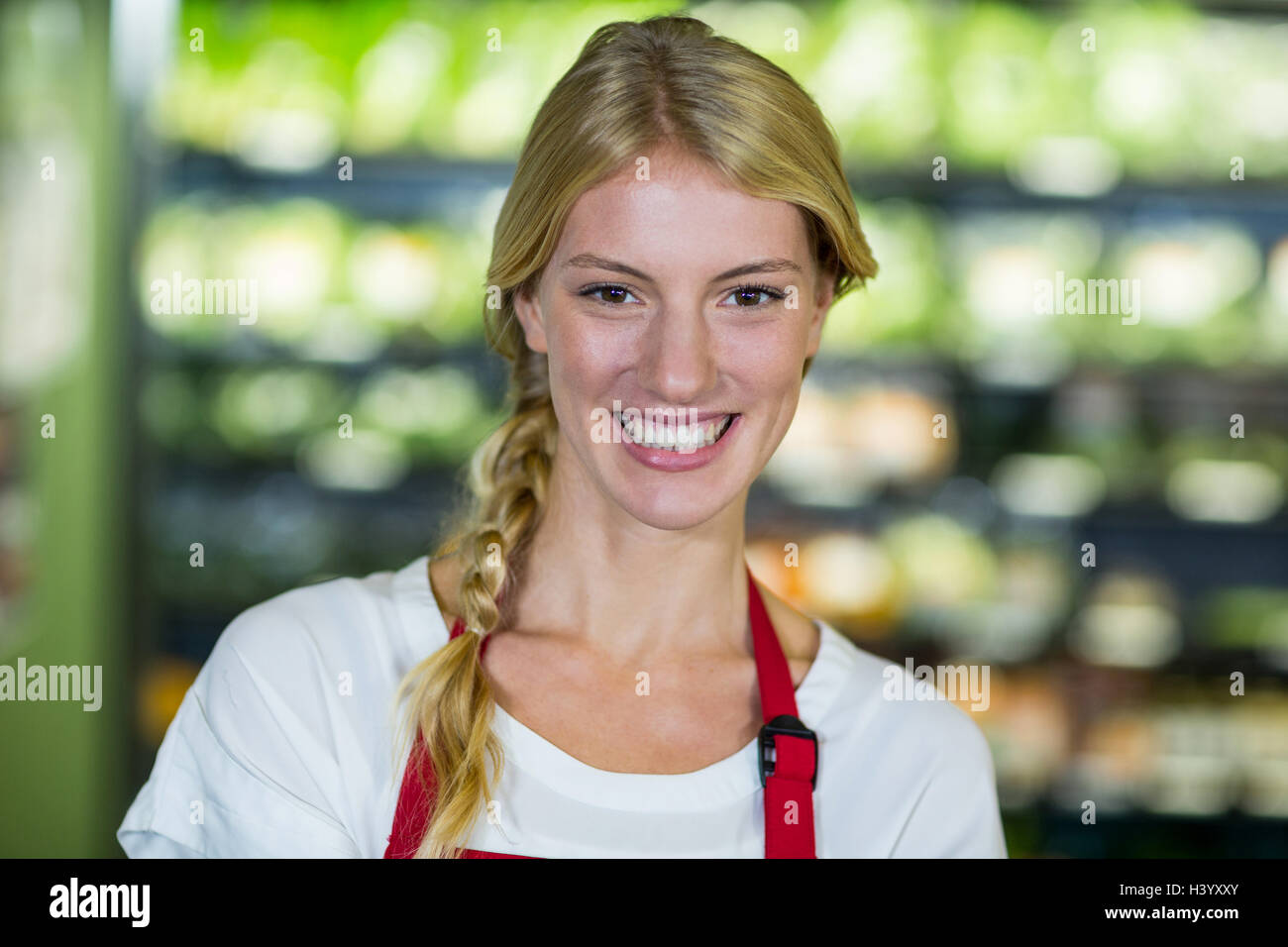 Smiling staff in supermarket Stock Photo - Alamy