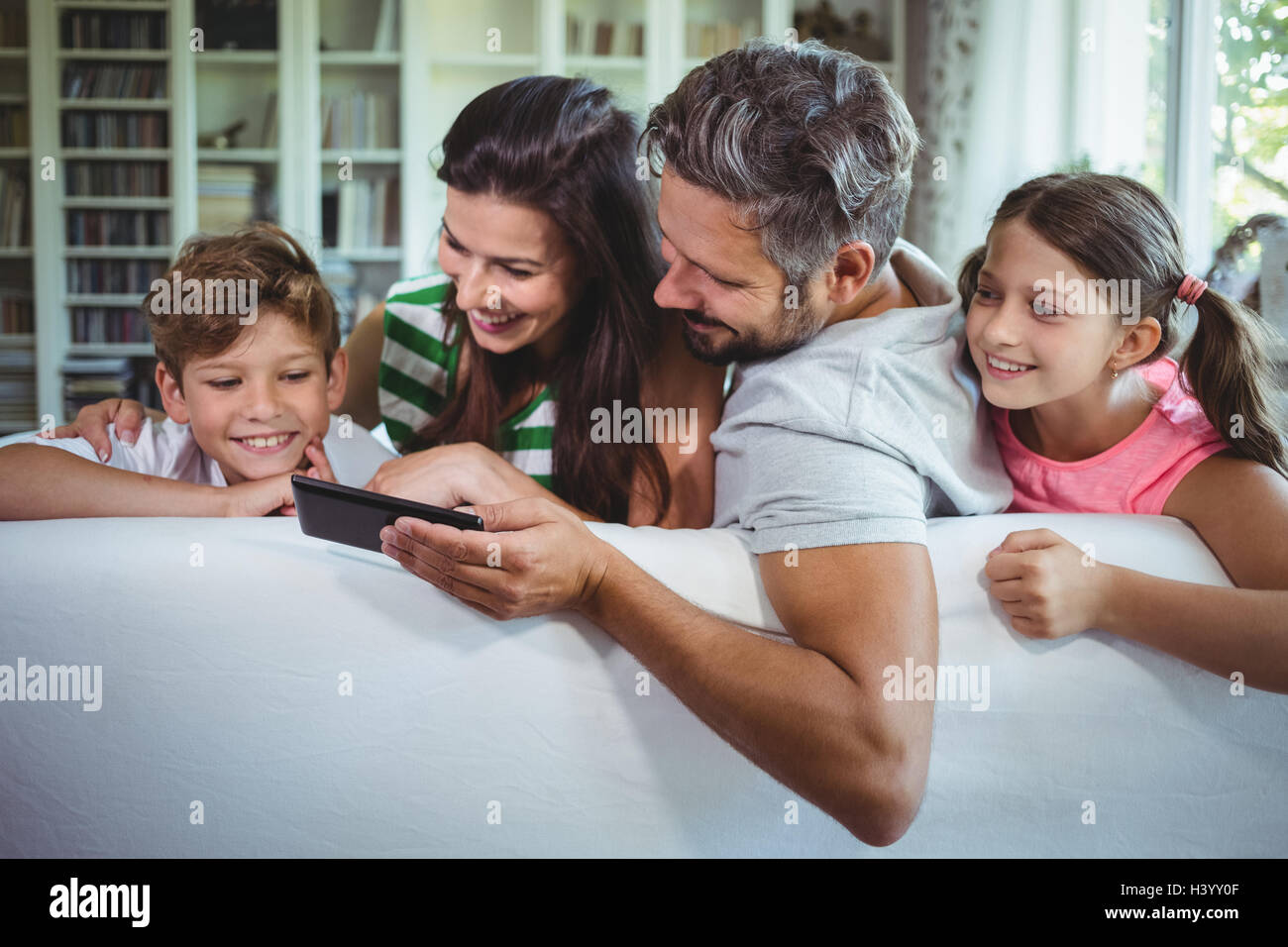 Happy children using mobile hi-res stock photography and images - Alamy