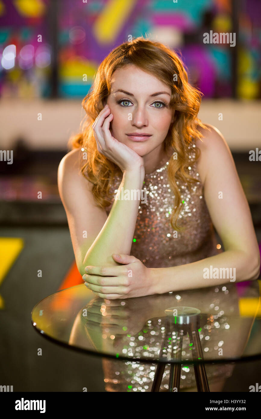 Portrait of young woman leaning on table Stock Photo - Alamy