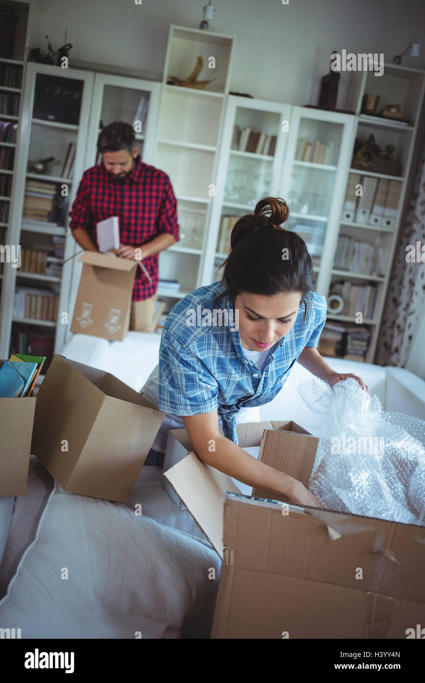 Couple unpacking cartons together Stock Photo - Alamy