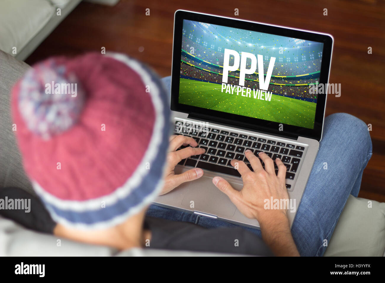 Young man watchin pay per view sports event. All screen graphics are ...