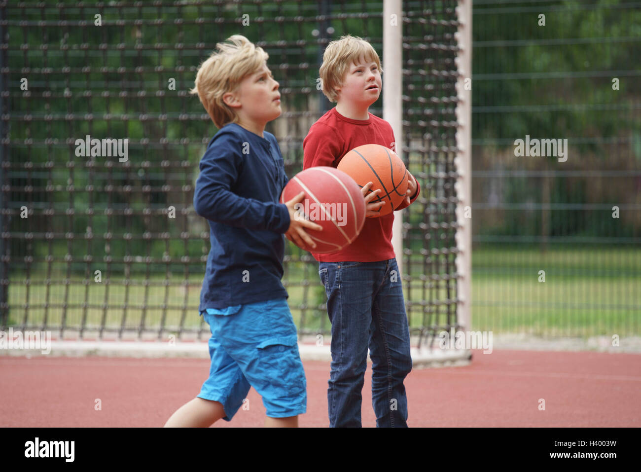 Boys holding basketballs while looking up at court Stock Photo - Alamy