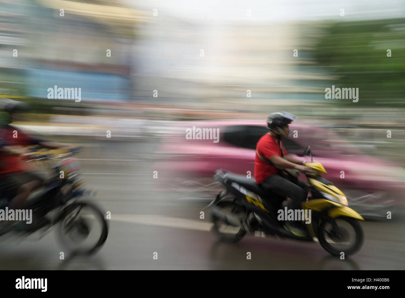 Slow camera shutter speed exaggerating movement of motorcycle riders in ...