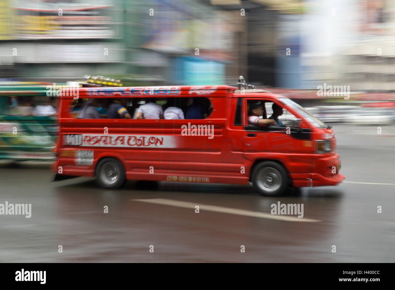 Slow camera shutter speed exaggerating movement of a multicab public ...