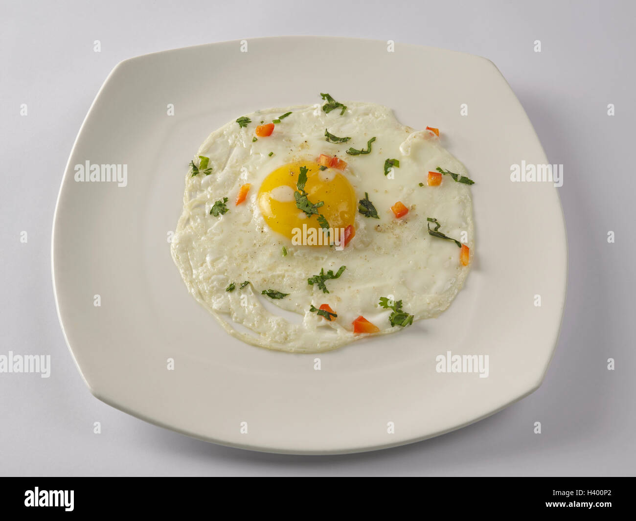Bullseye egg served in a plate on a white background Stock Photo - Alamy