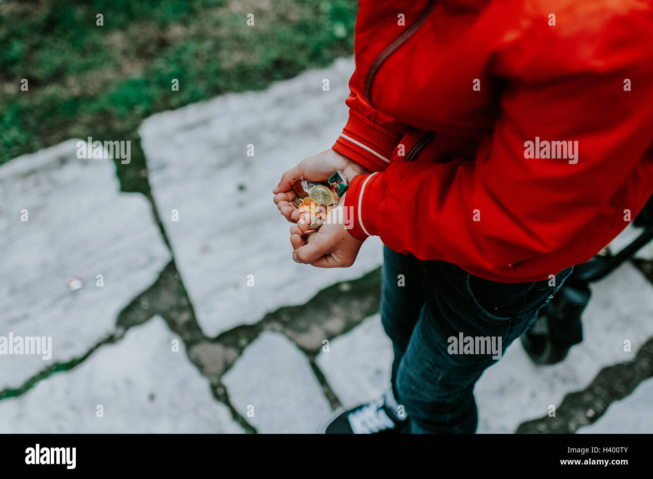 Boy with a handful of sweets Stock Photo - Alamy