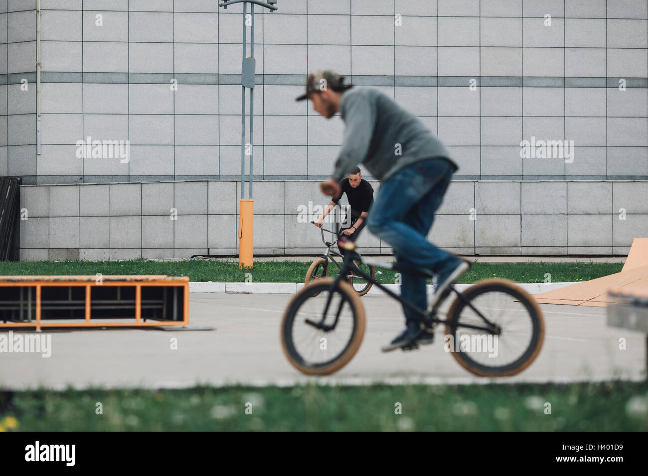 Teenagers cycling at skateboard park Stock Photo - Alamy