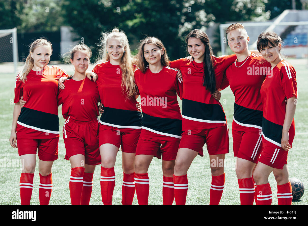 Portrait of smiling soccer players standing on field Stock Photo - Alamy