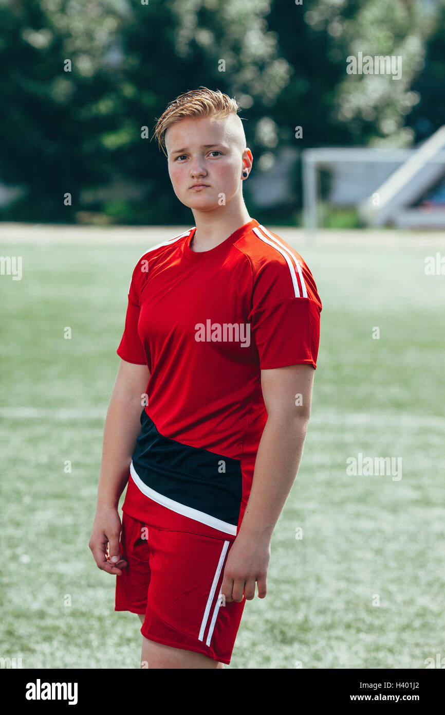 Portrait of teenage soccer player standing on field Stock Photo - Alamy