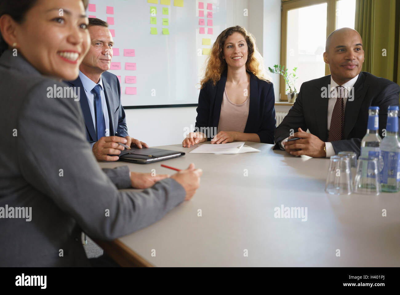 Smiling business people sitting in meeting at conference room Stock ...