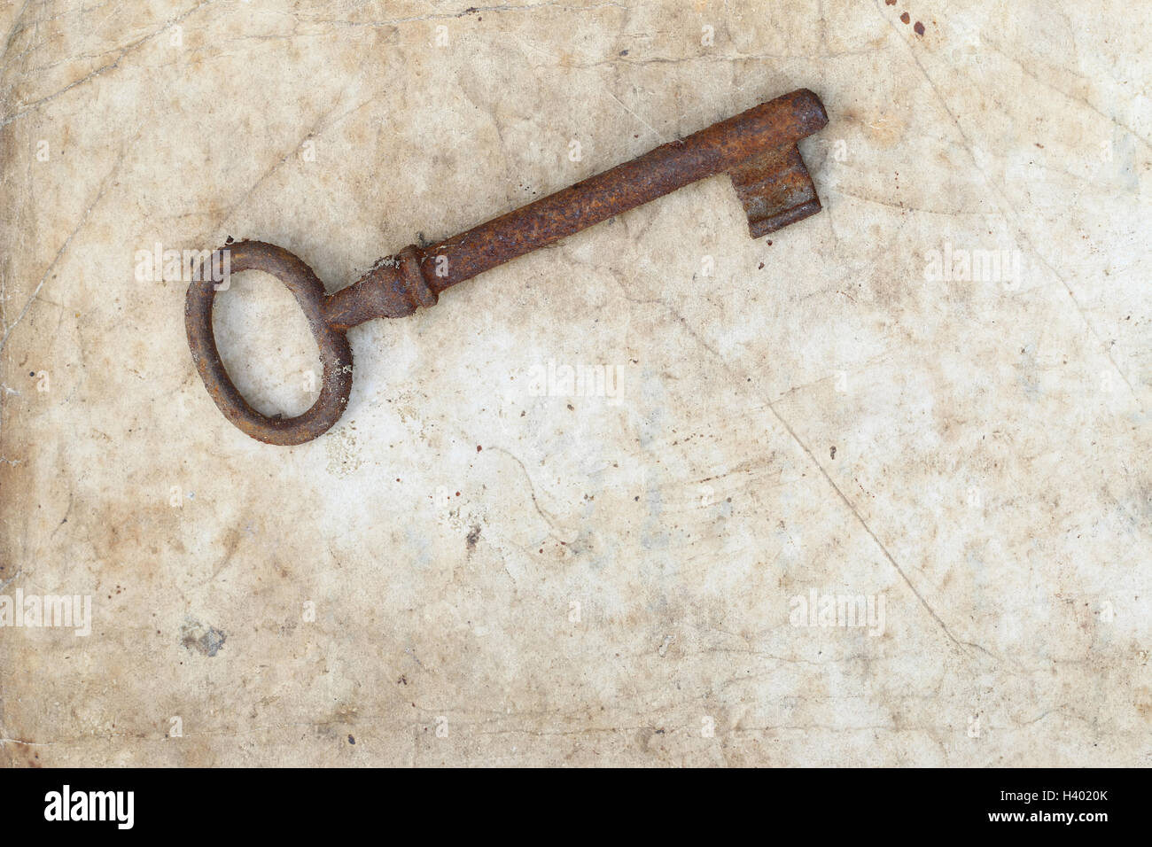 Rusty key on old parchment Stock Photo - Alamy