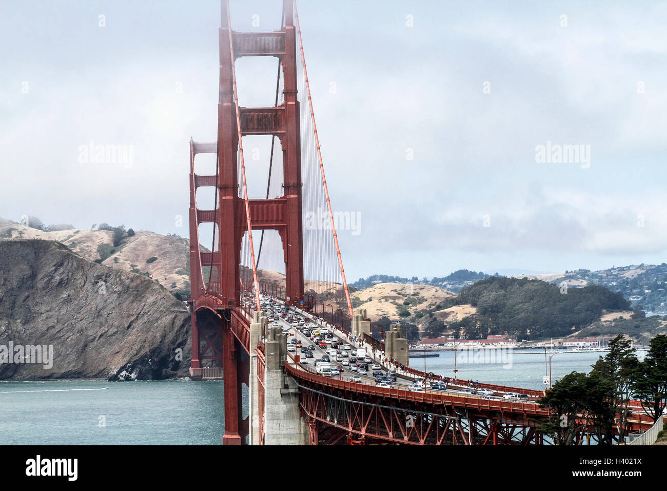 View of Golden Gate Bridge over bay of water against mountain during ...