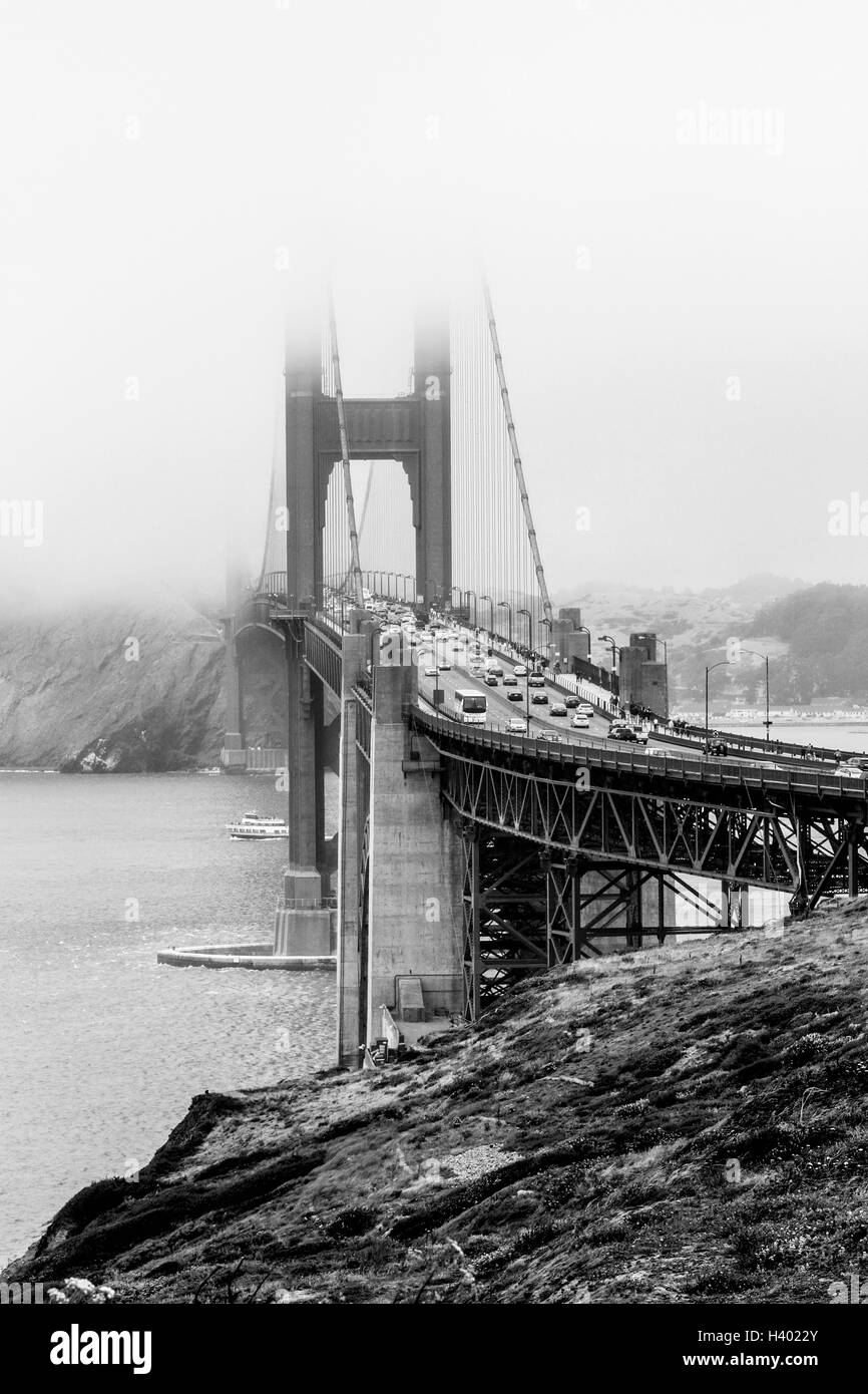 Golden Gate Bridge over Bay against mountain during foggy weather, San ...