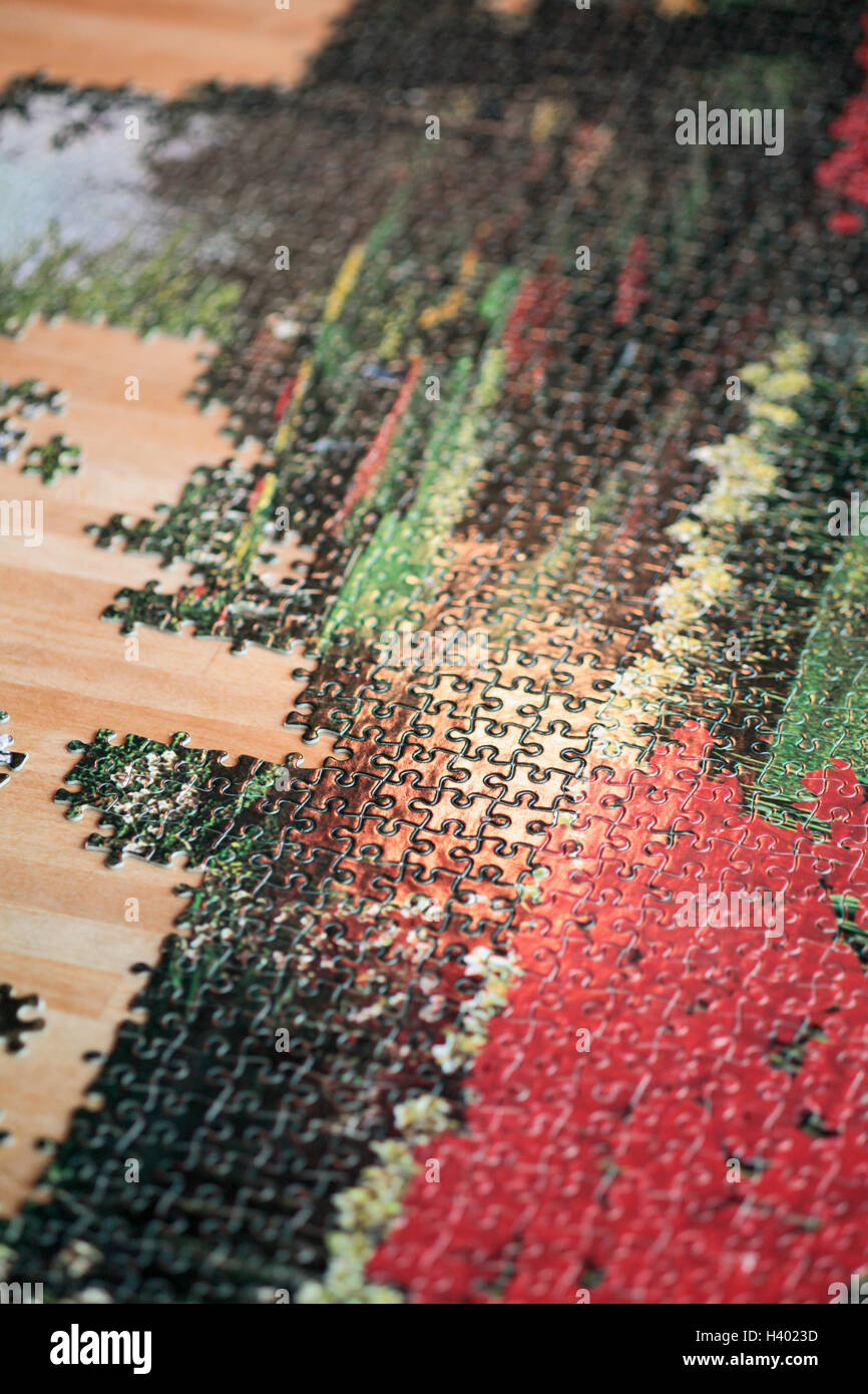 High angle view of incomplete jigsaw puzzle on wooden table Stock Photo ...