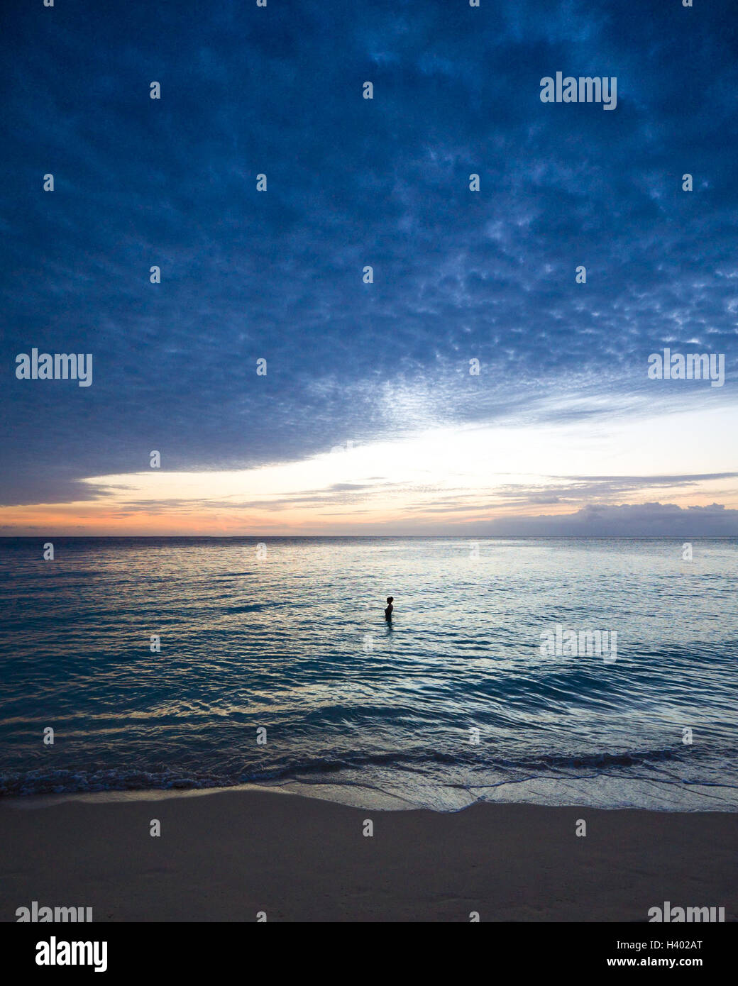 Girl standing in ocean at sunset, Barbados, Caribbean Stock Photo - Alamy