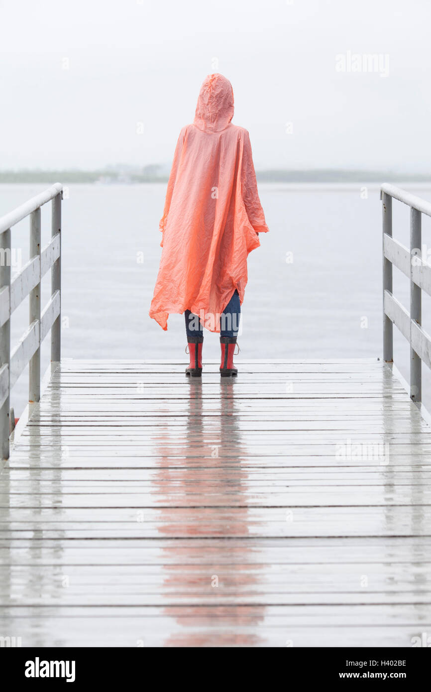 Rear view woman wearing raincoat hi-res stock photography and images ...
