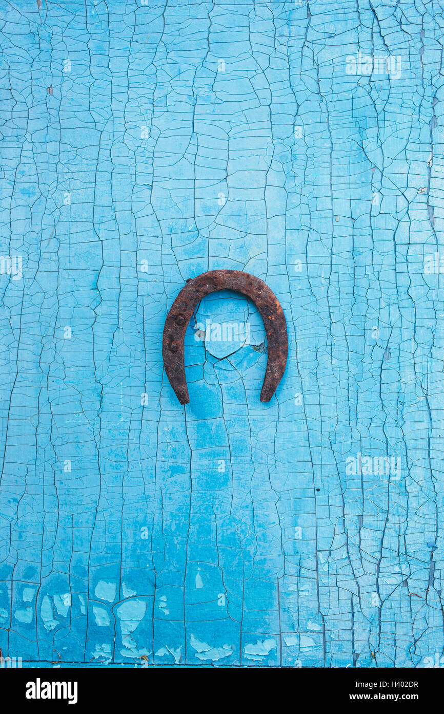 Directly above shot of metallic rusty horseshoe on old blue table Stock ...