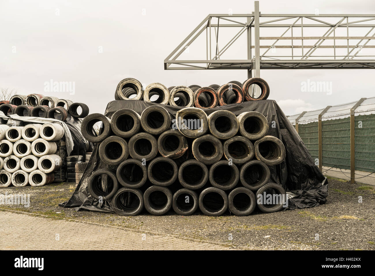 Stack of old tires on field against clear sky Stock Photo - Alamy