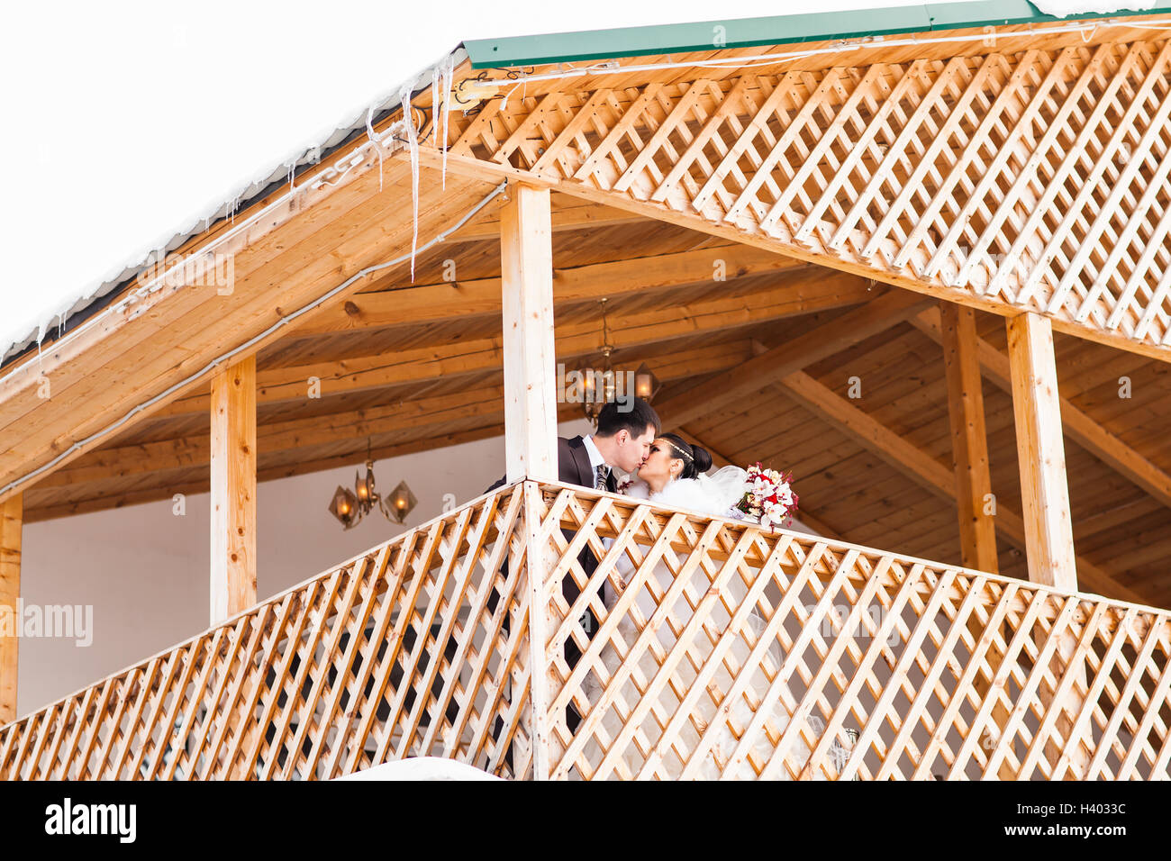 Romantic kiss happy bride and groom on winter wedding day Stock Photo ...