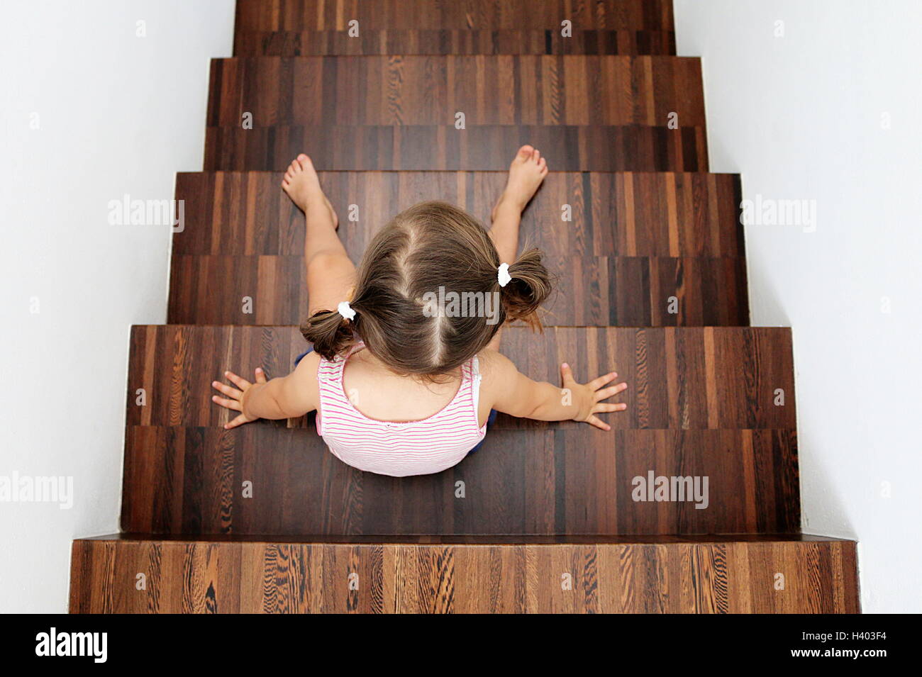 Girl sitting on wooden steps Stock Photo - Alamy