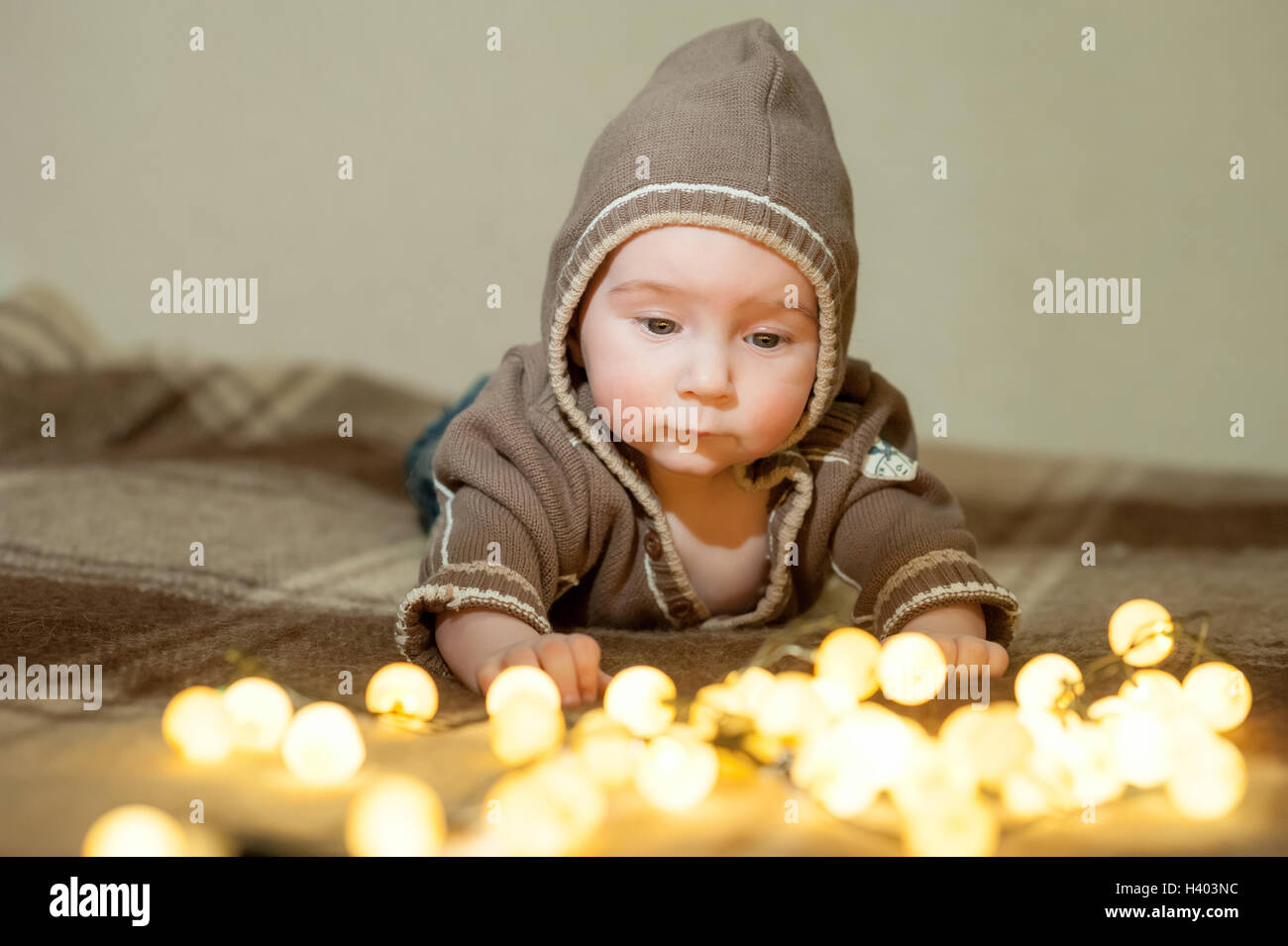 Cute baby playing on the bed, smiling and posing to camera Stock Photo ...