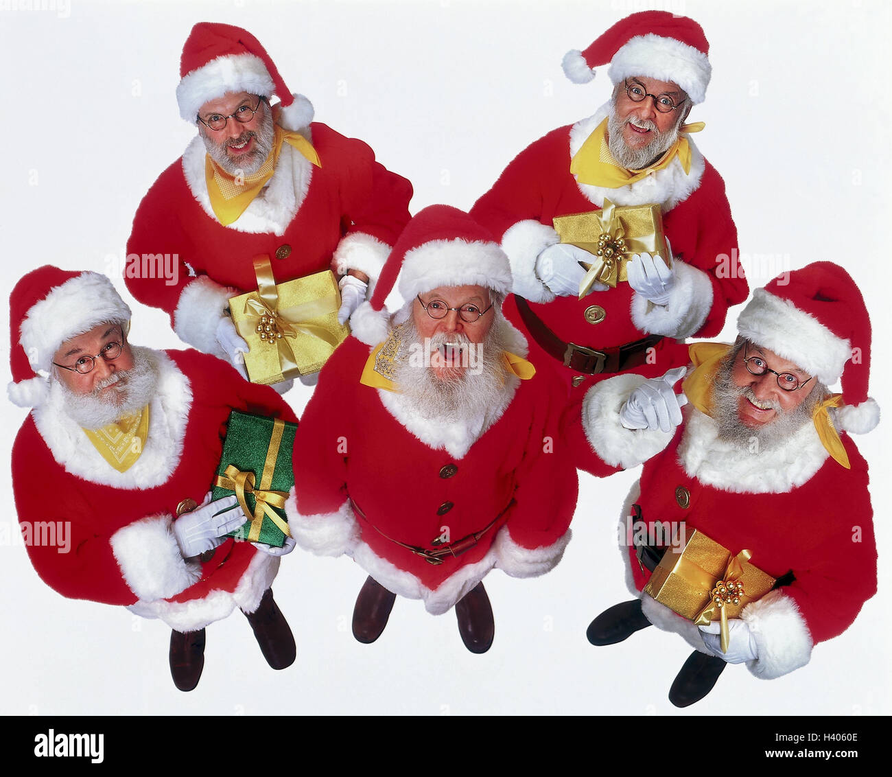 Santas, presents, facial play, joy, group picture inside, studio, cut ...