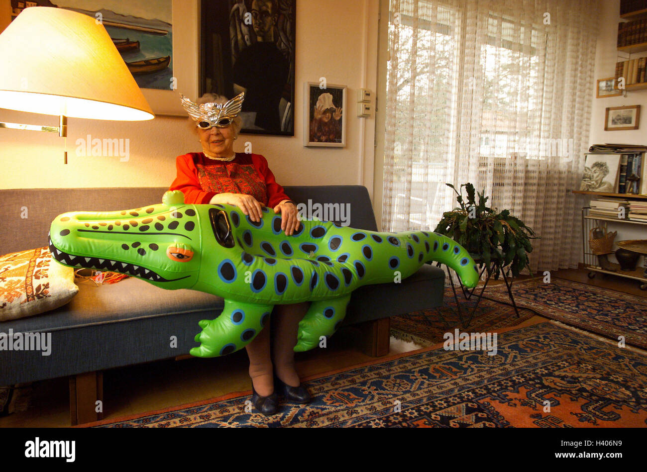 Senior, carnival glasses, sofa, sit, hold swimming animal, crocodile ...