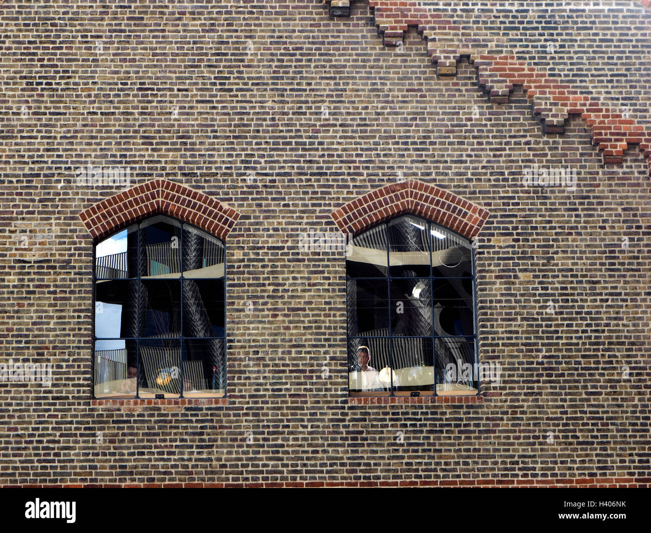 elaborate brick building near Kings Cross with reflections of head and ...